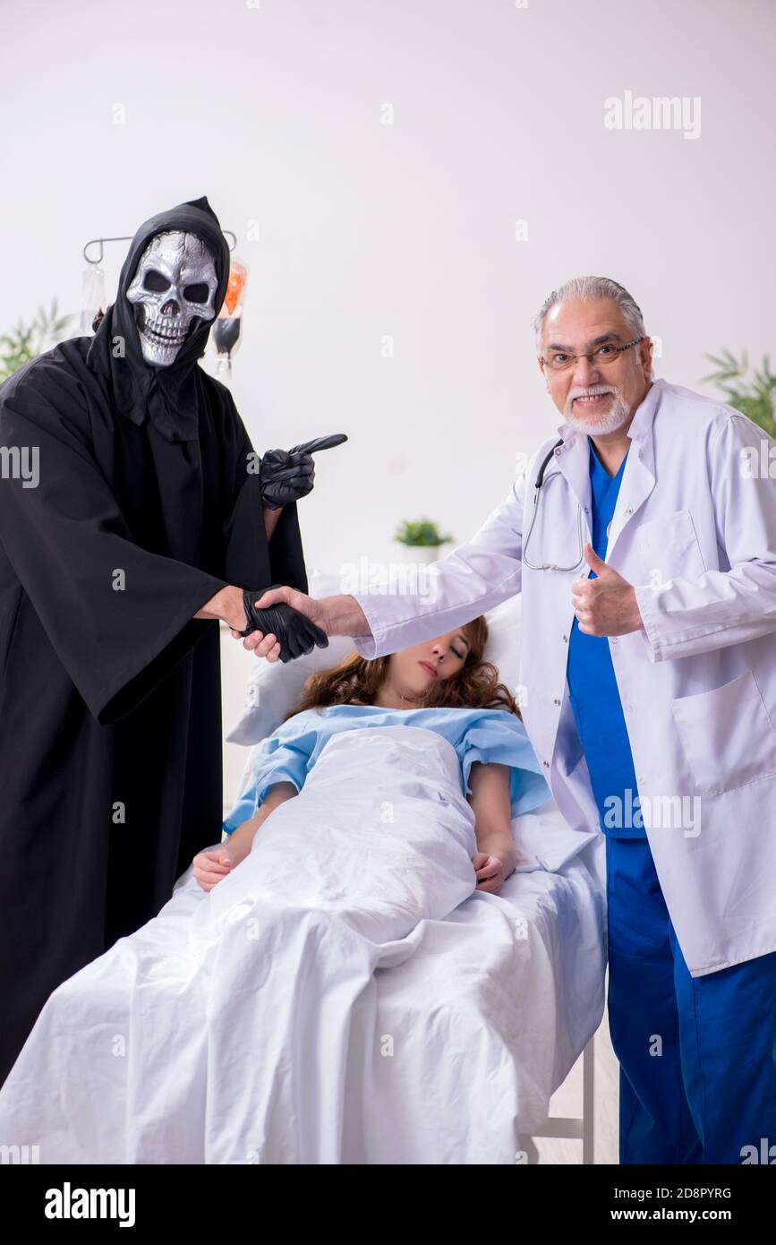 Devil, old doctor and female patient in clinic Stock Photo - Alamy