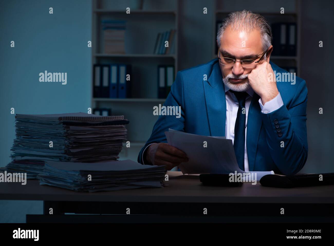 Old employee working late in the office Stock Photo - Alamy