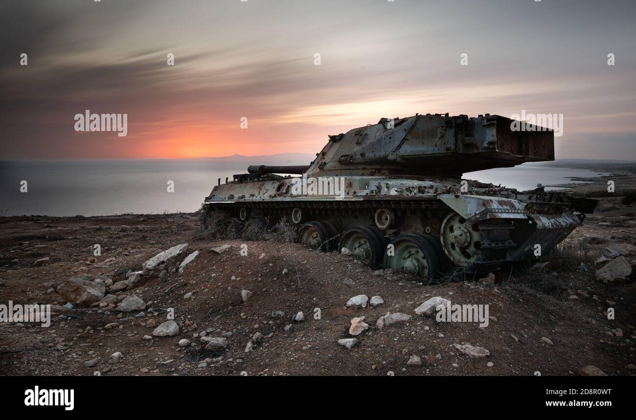 Old rusty abandoned military tank in the field at sunset Stock Photo ...