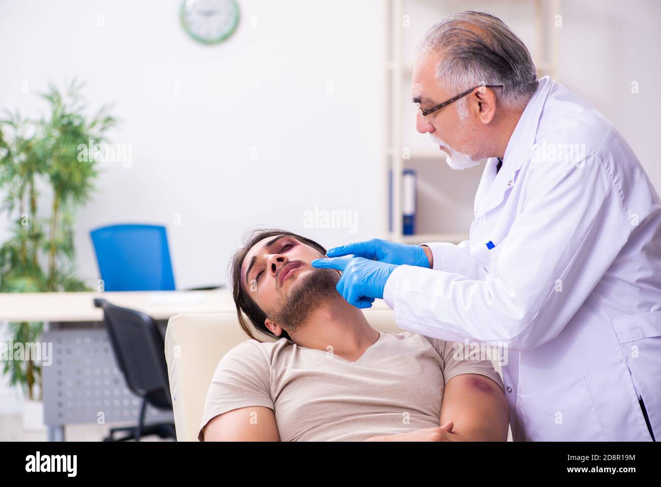 Young face injured man visiting experienced male doctor traumatologist ...