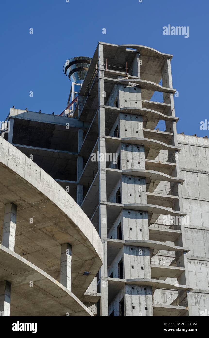 Concrete building of an unfinished skyscraper. A series of repeating ...