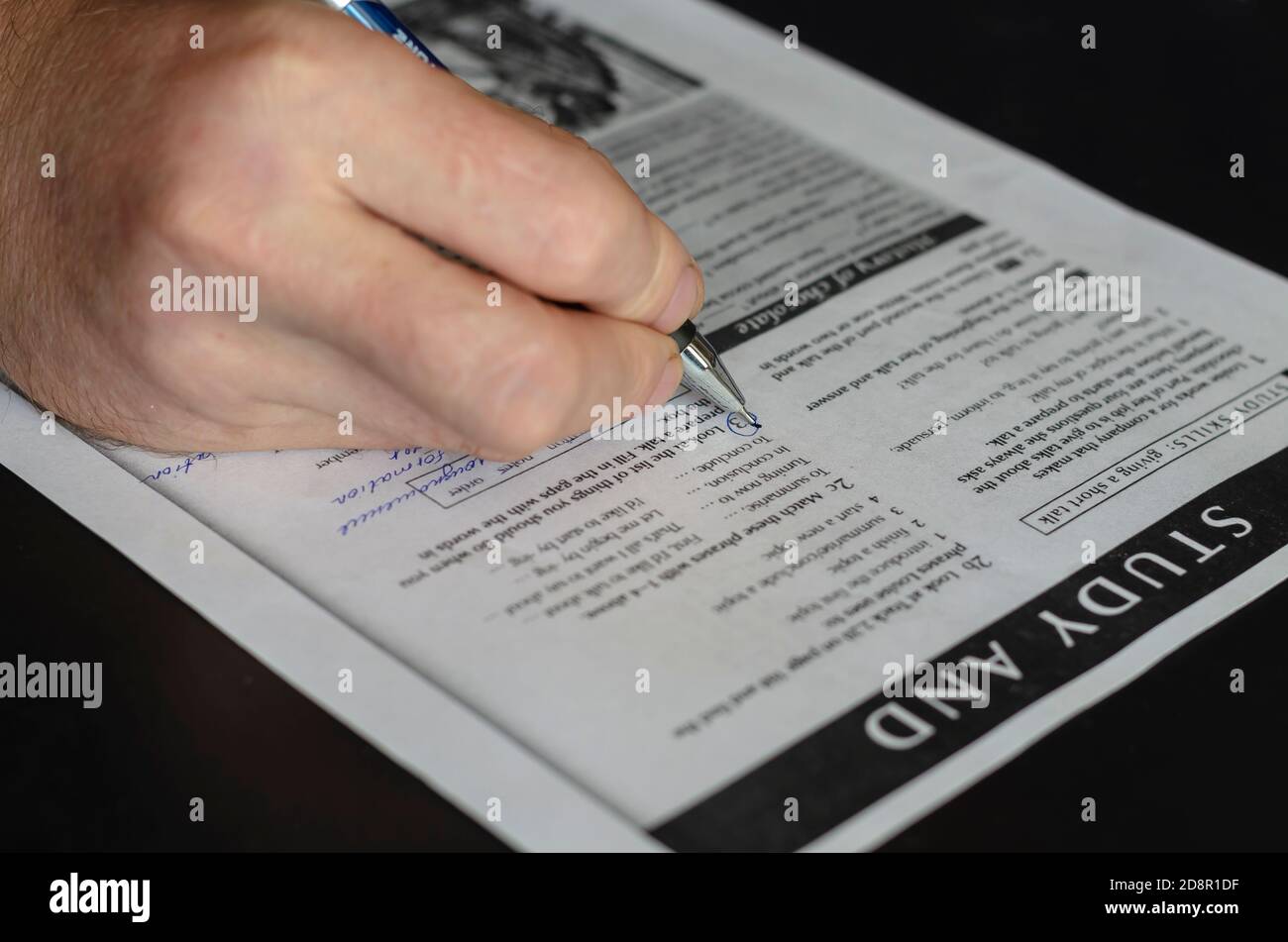 Adult Man takes an English test. Partially completed multiple choice ...