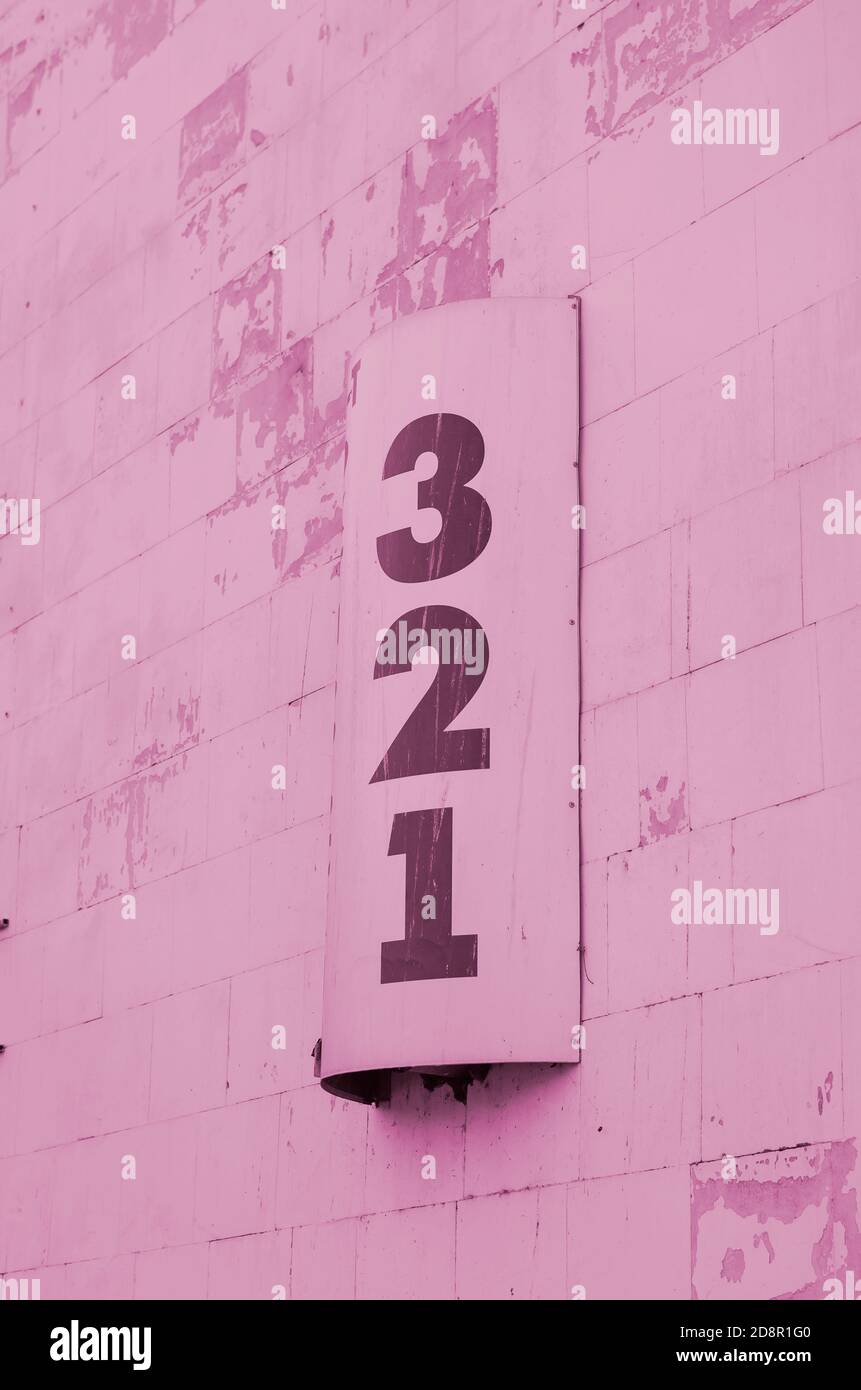 Semicircular sign on the wall with numbers 3,2,1. Vertical signboard on ...