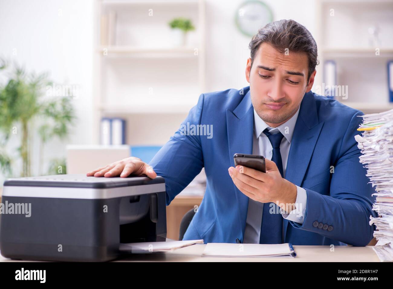 Young employee making copies at copying machine Stock Photo - Alamy