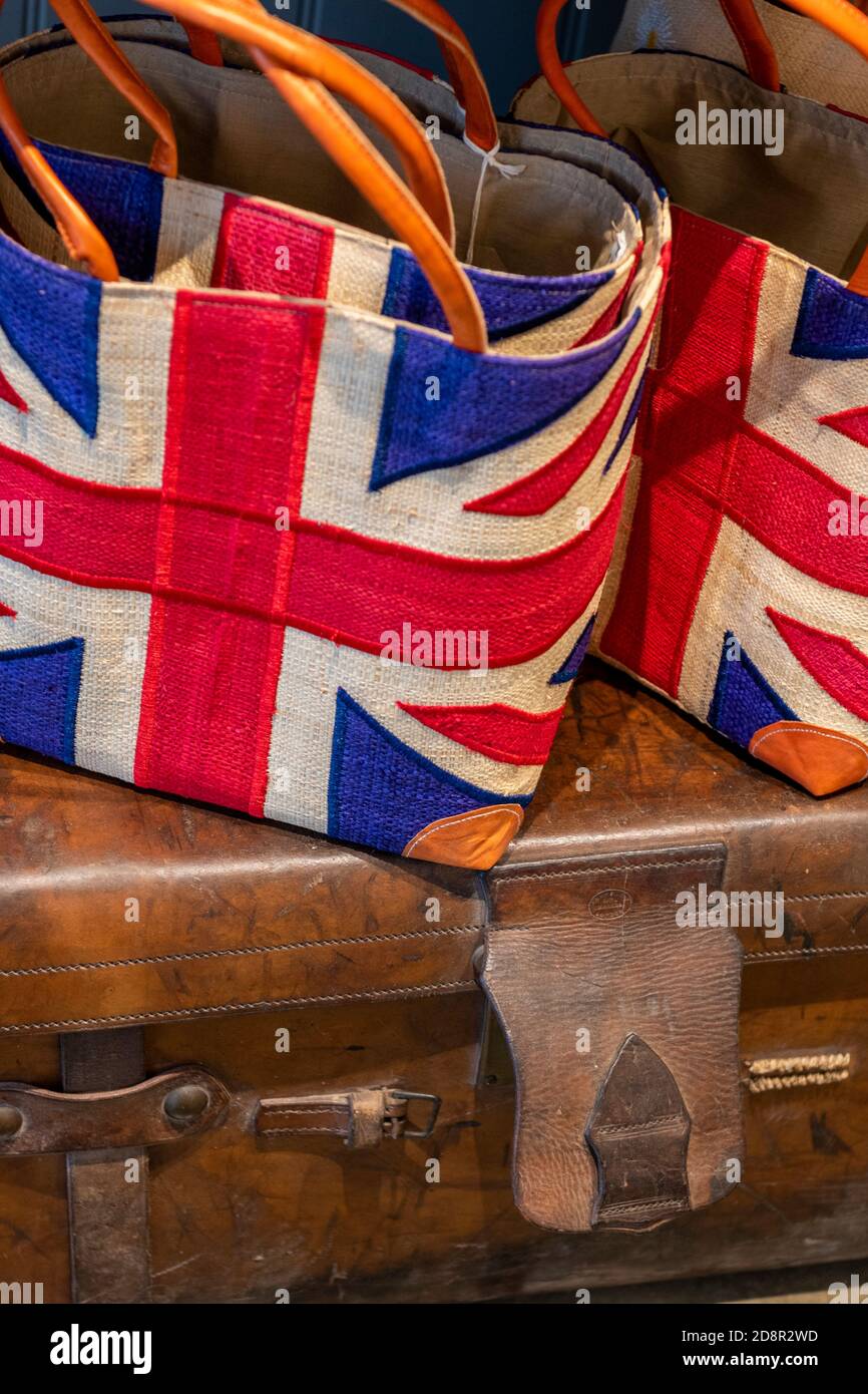 an old leather suitcase and a union jack flag in a nostalgic historic ...