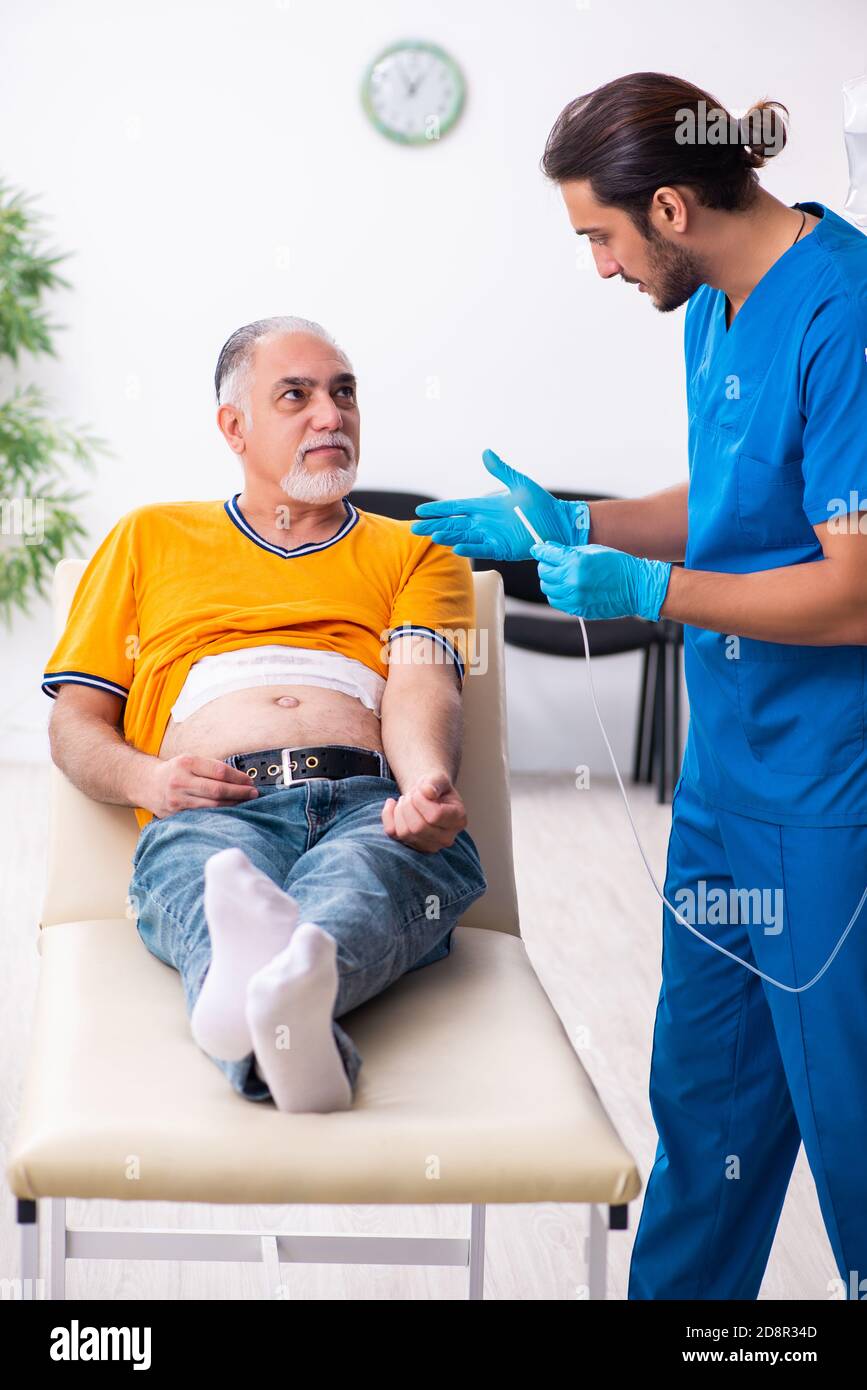 Old man visiting male doctor Stock Photo - Alamy