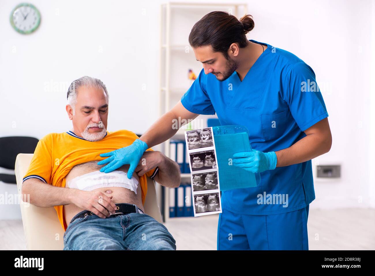 Old man visiting male doctor Stock Photo - Alamy