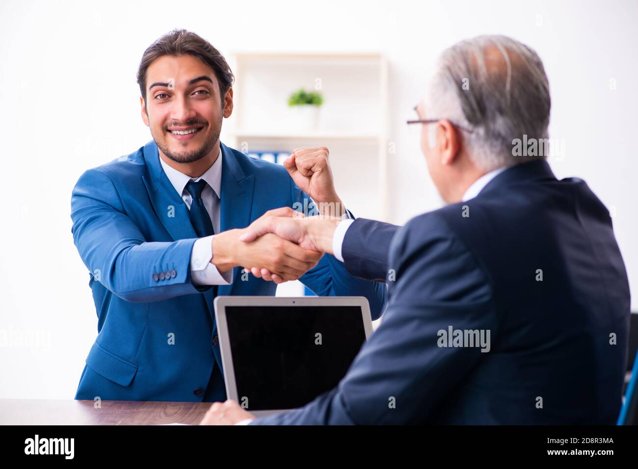Male candidate employee meeting with old recruiter Stock Photo - Alamy