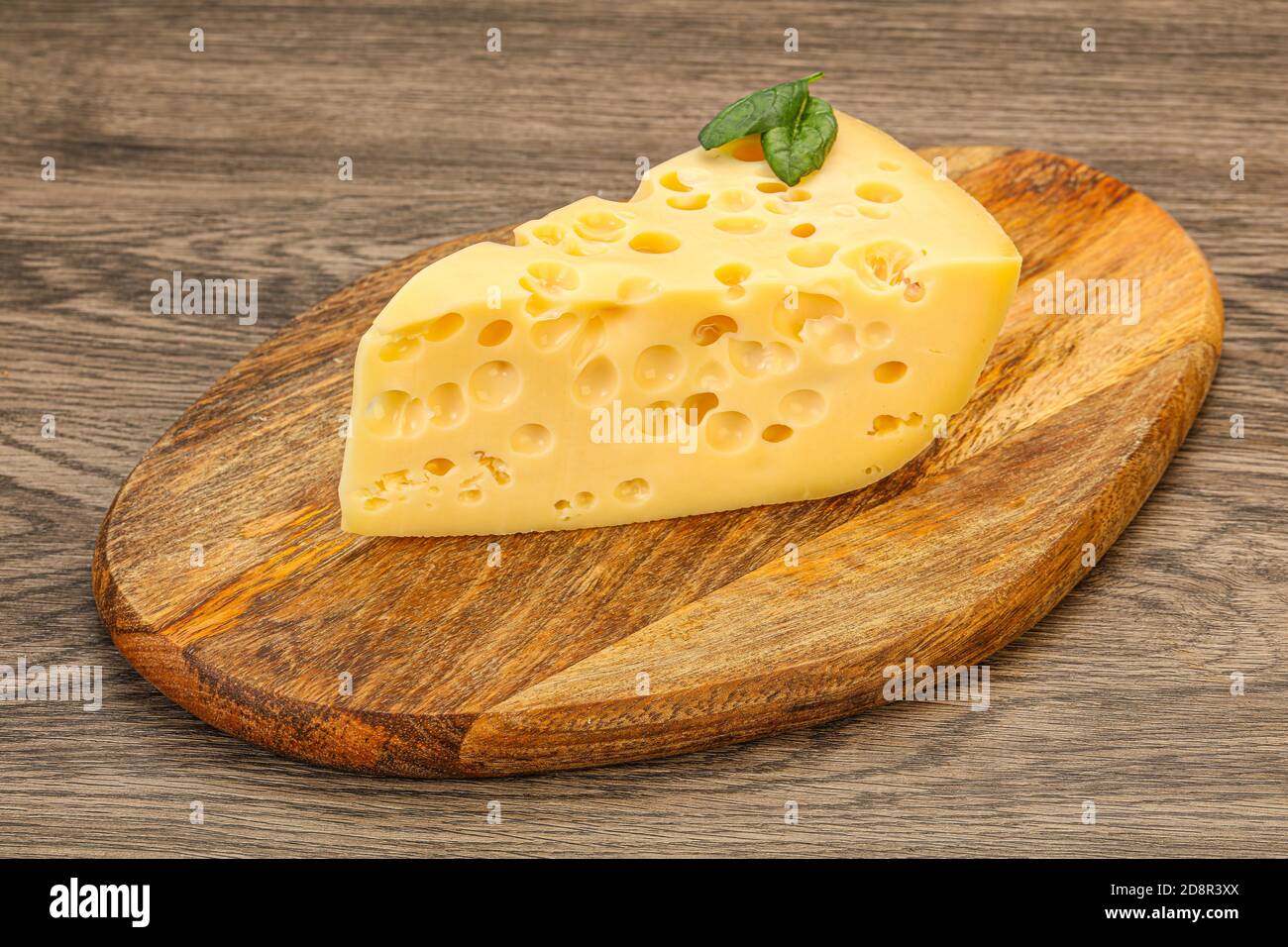 Maasdam cheese - dairy yellow triangle with holes Stock Photo - Alamy