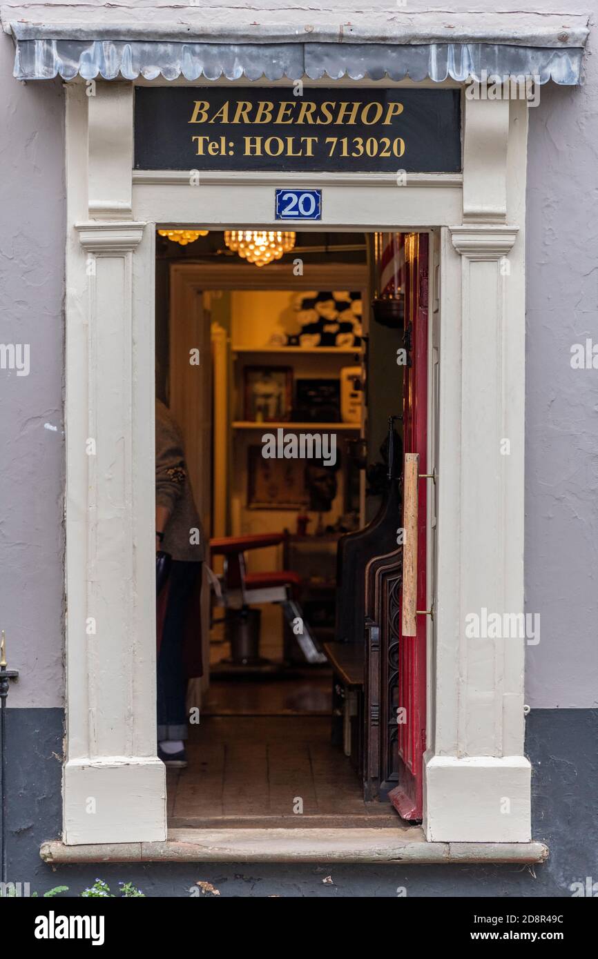 the doorway to a traditional georgian barbers shop in holt, norfolk, uk ...
