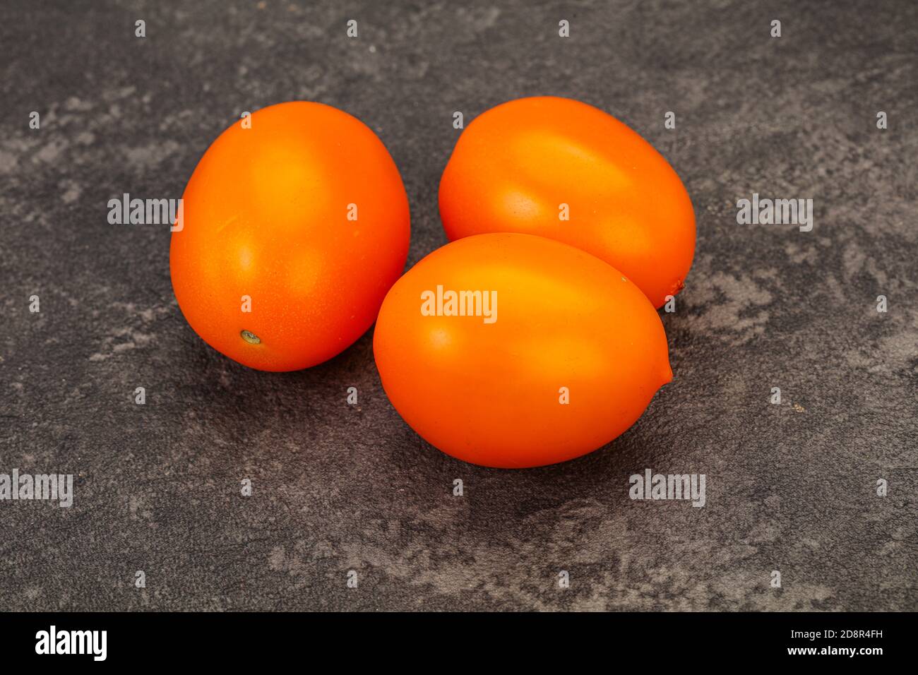 Tasty vegetables - Yellow tomato heap over background Stock Photo - Alamy