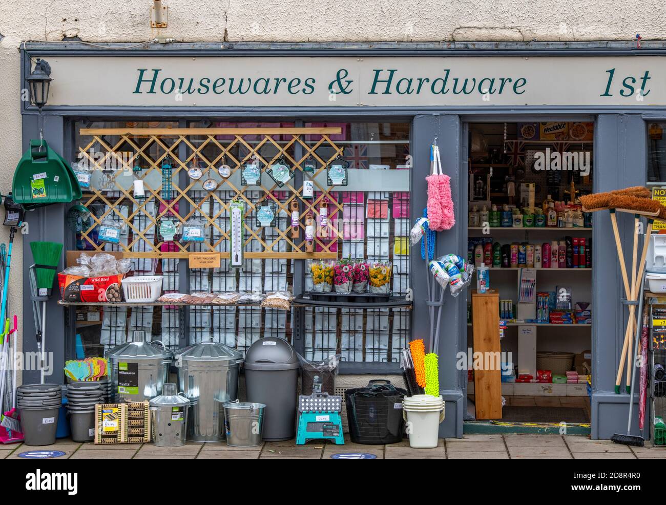a traditional hardware shop with goods displayed outside of the window ...