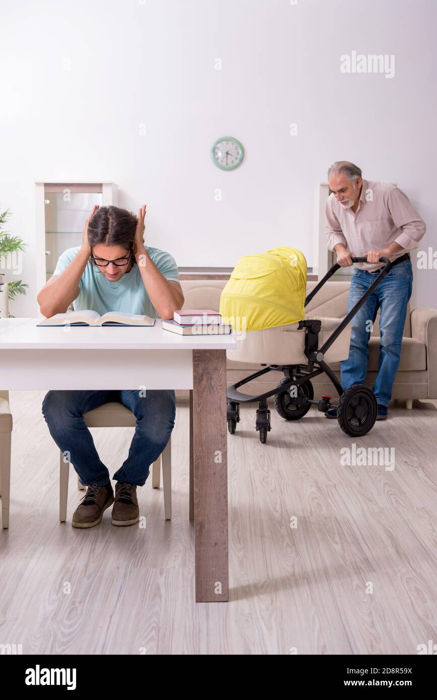 Old grandfather looking after newborn at home Stock Photo - Alamy