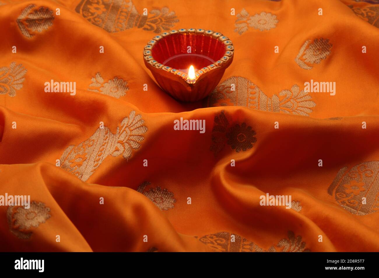 diwali diya or clay lamp placed over silk cloth Stock Photo - Alamy