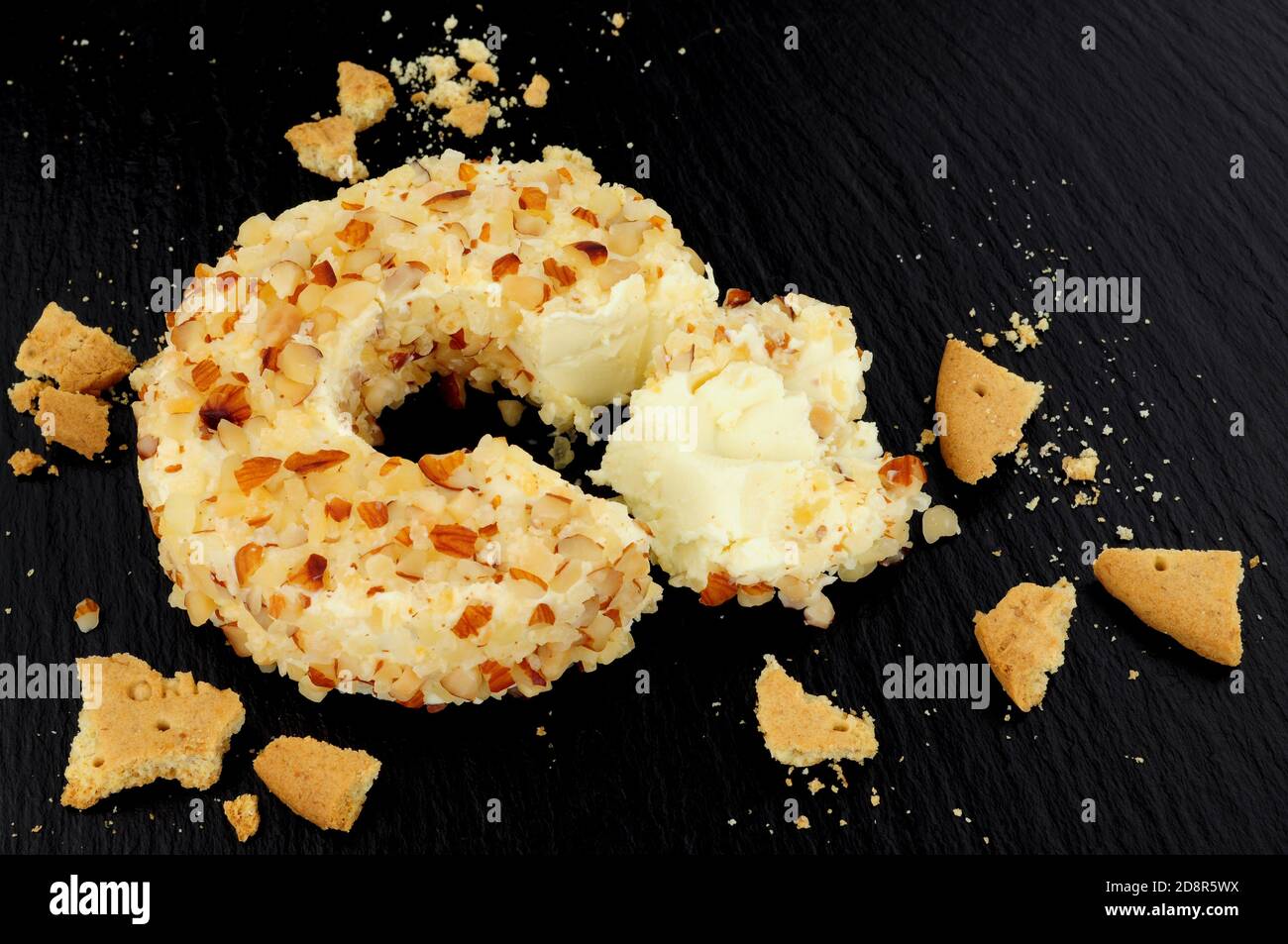 Pineapple flavour soft cream cheese ring coated in crushed almonds on a ...