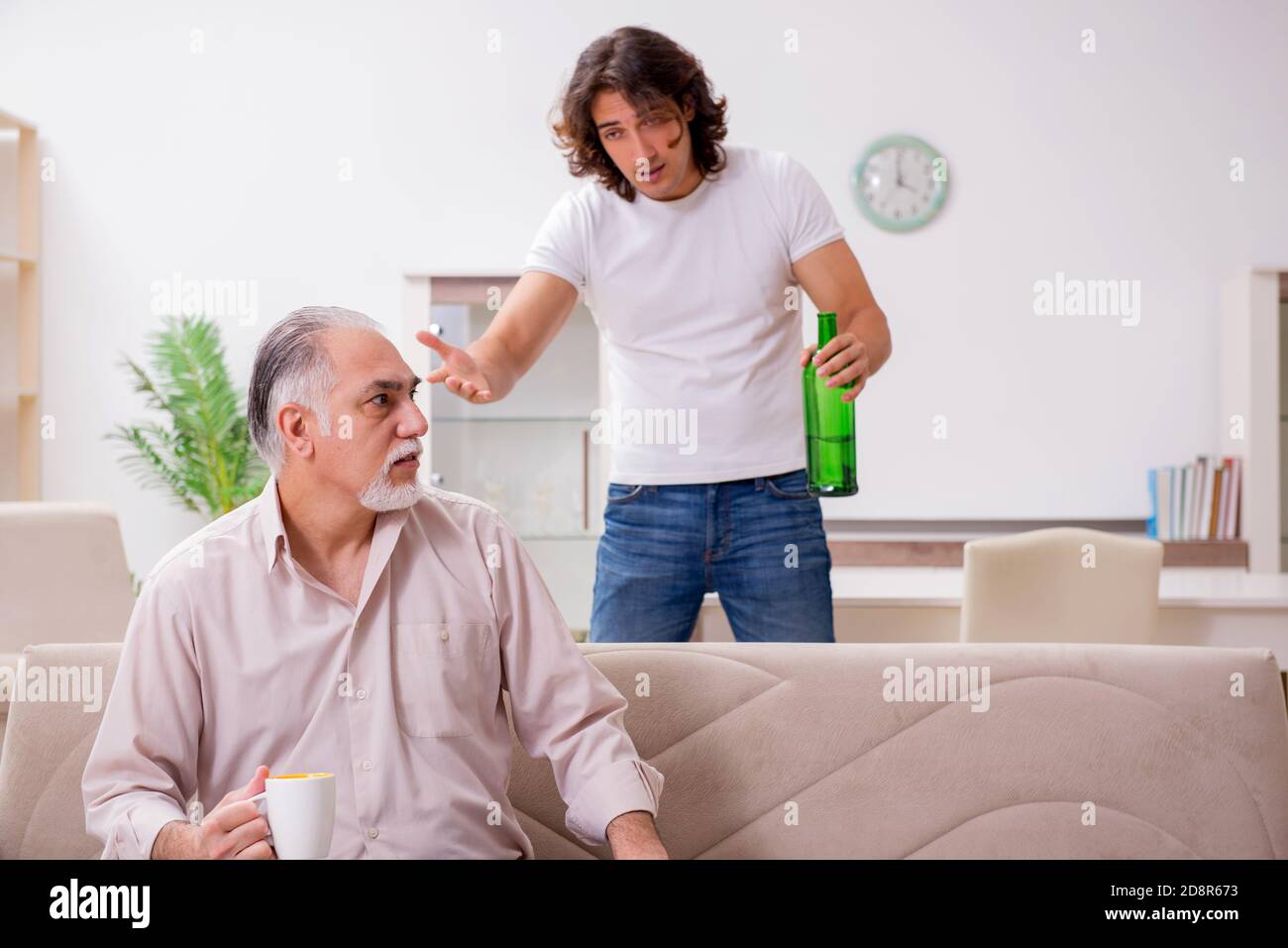 Drinking problems in the family between son and father Stock Photo - Alamy