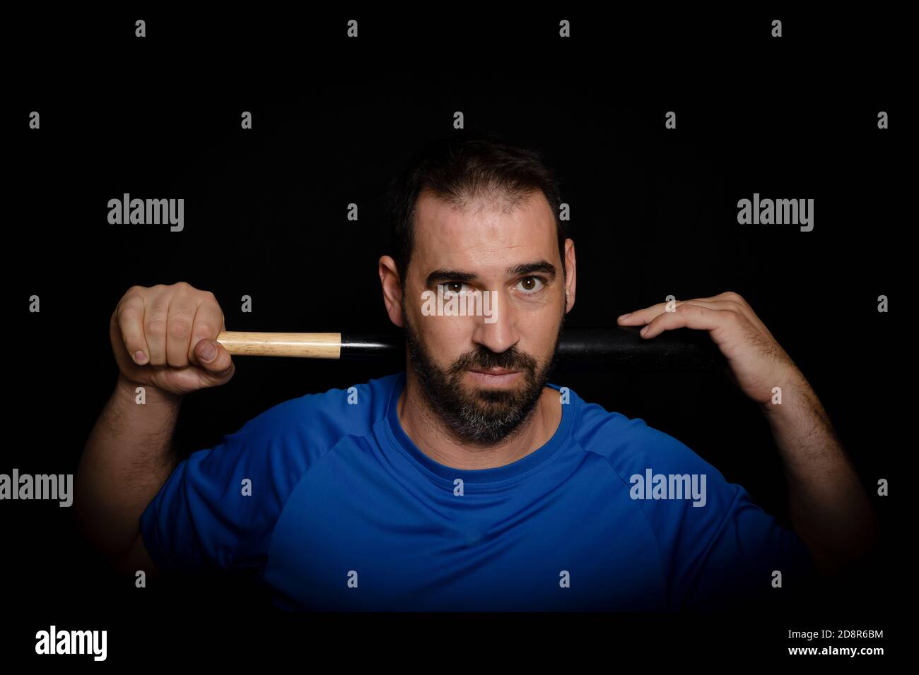 Bearded man dressed in blue t-shirt in defiant pose posing with a ...