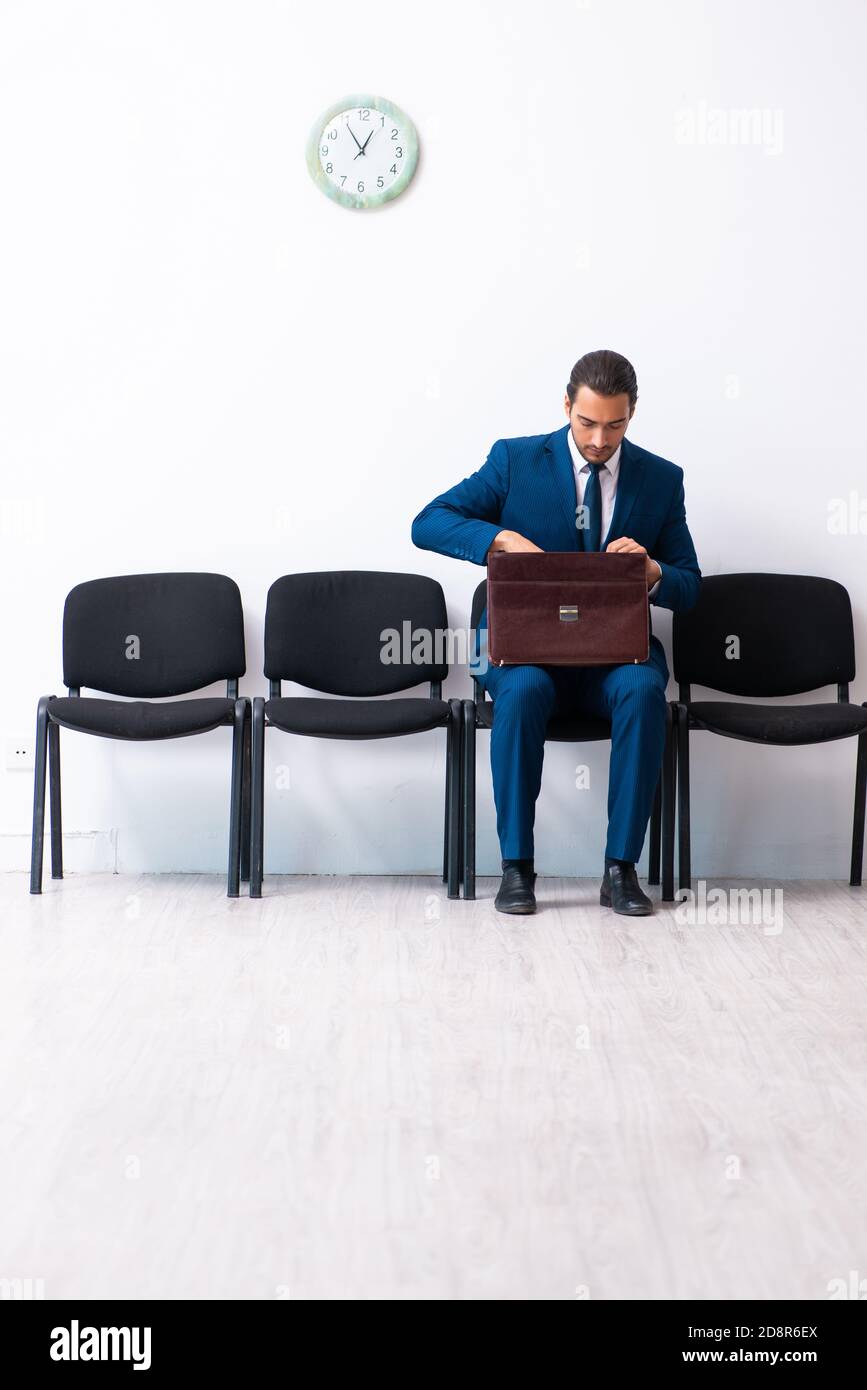Businessman waiting for an interview at hall Stock Photo - Alamy