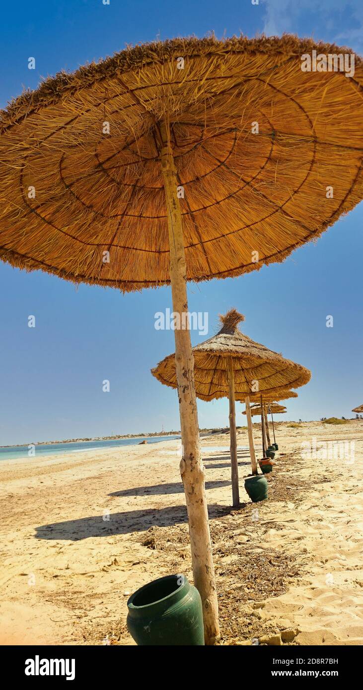 straw parasol on a beach Stock Photo - Alamy