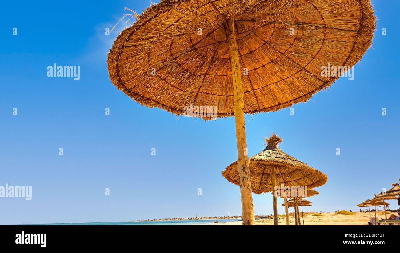 straw parasol on a beach Stock Photo - Alamy