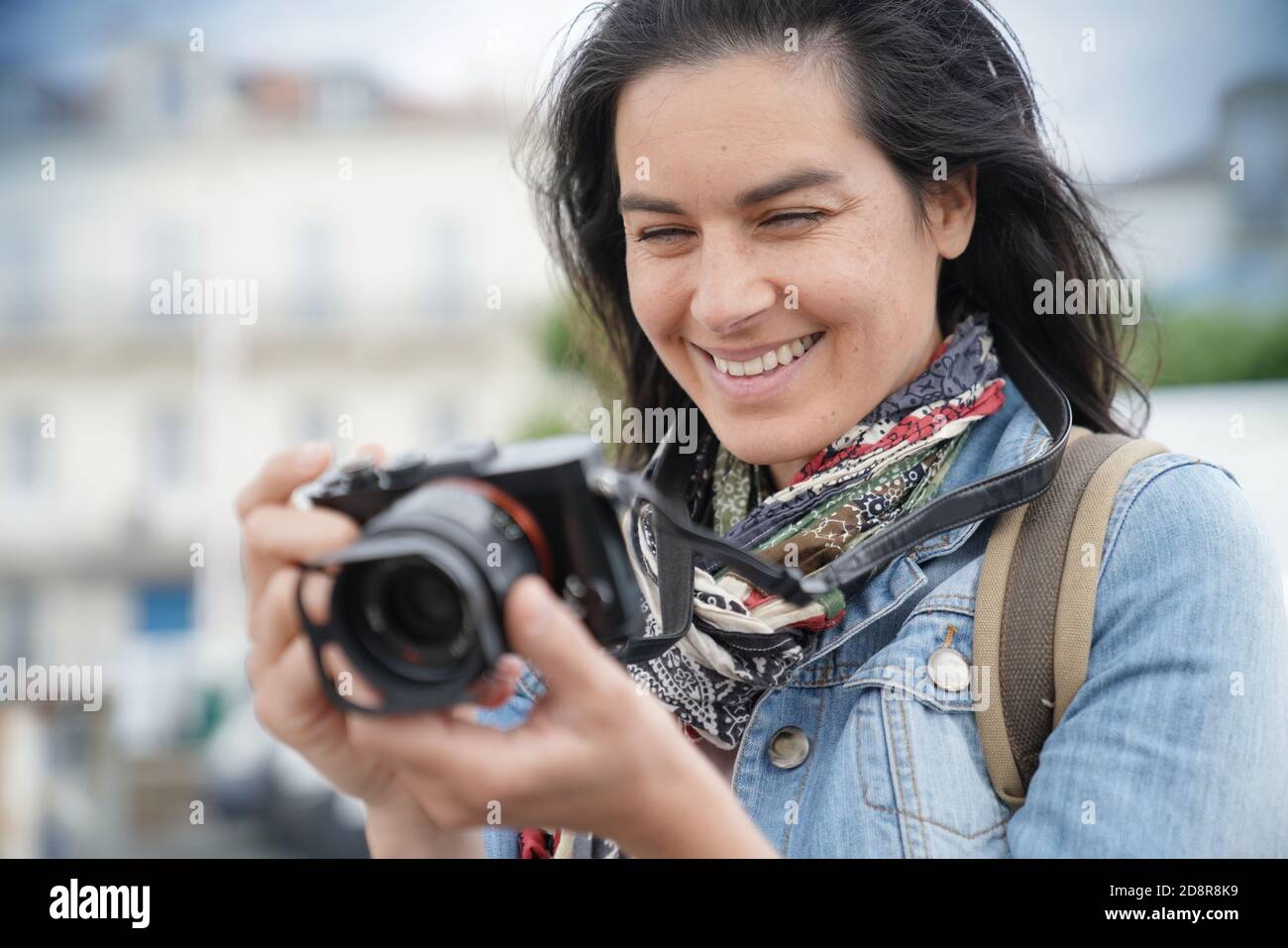 Portrait of woman reporter taking pictures with reflex camera Stock ...