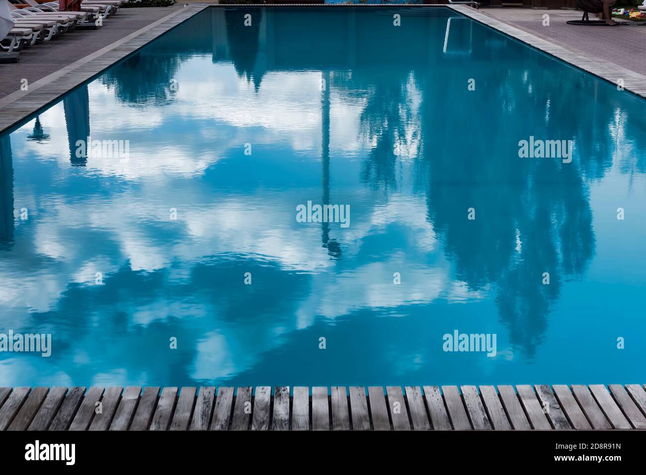 Pool with blue water. Reflection of a cloudy sky in the water Stock ...