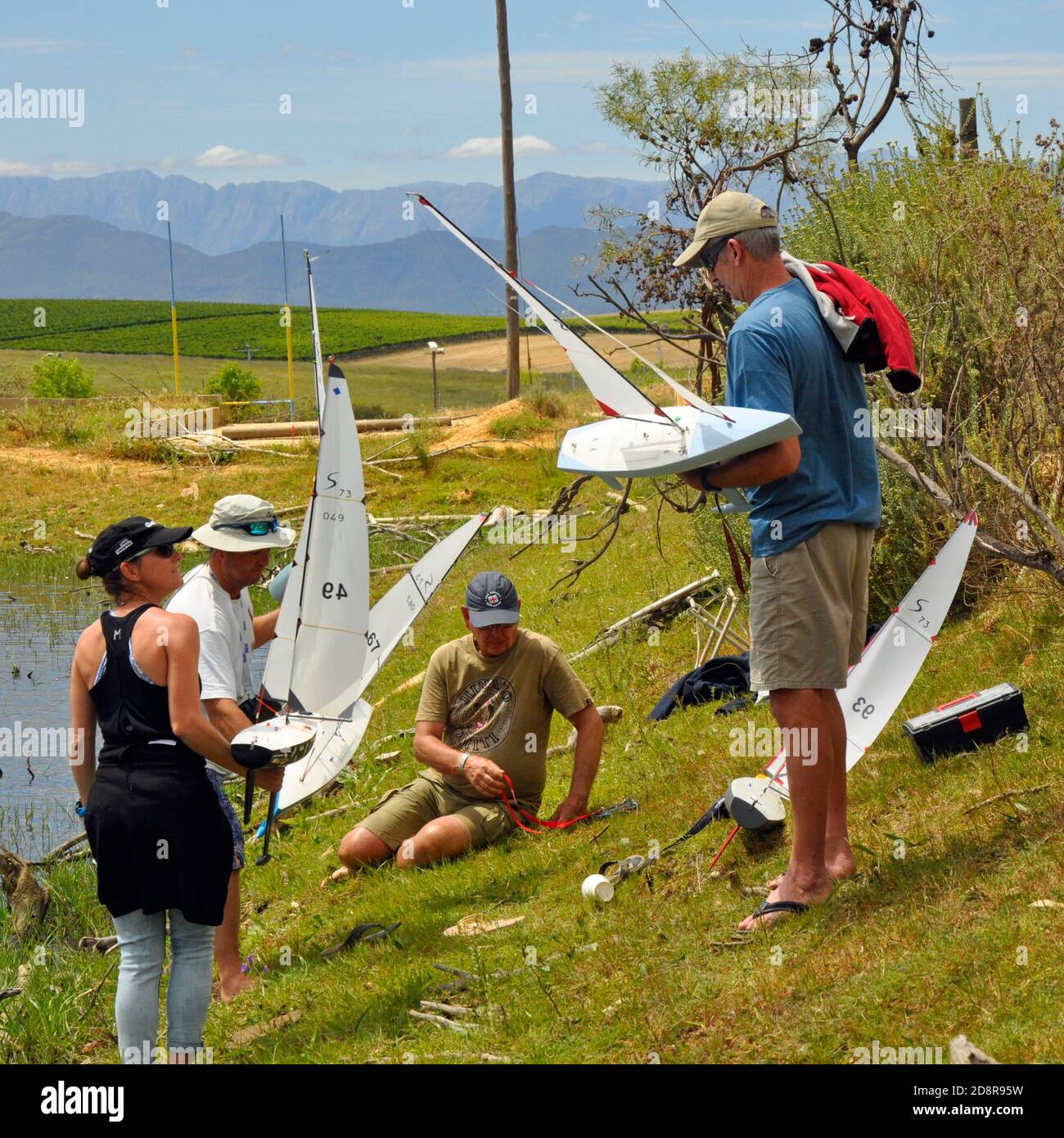 Model yacht enthusiasts with their boats beside a lake Stock Photo - Alamy