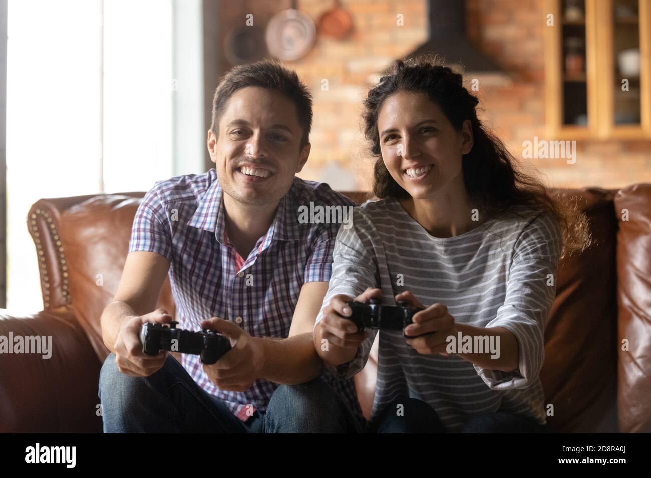 Smiling couple have fun playing video games Stock Photo - Alamy