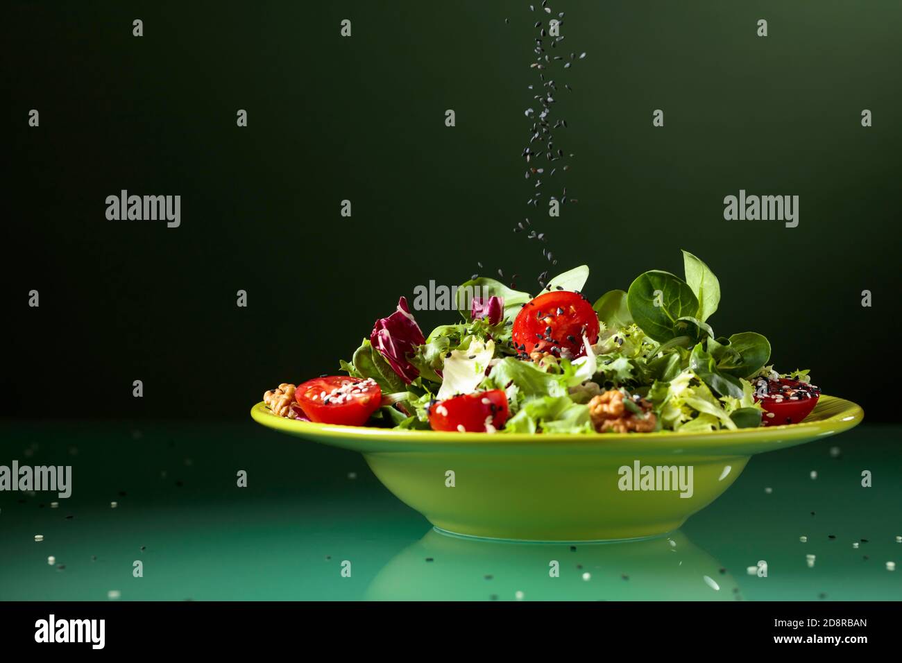 Green salad with cherry tomatoes, walnuts and vegetable oil sprinkle ...