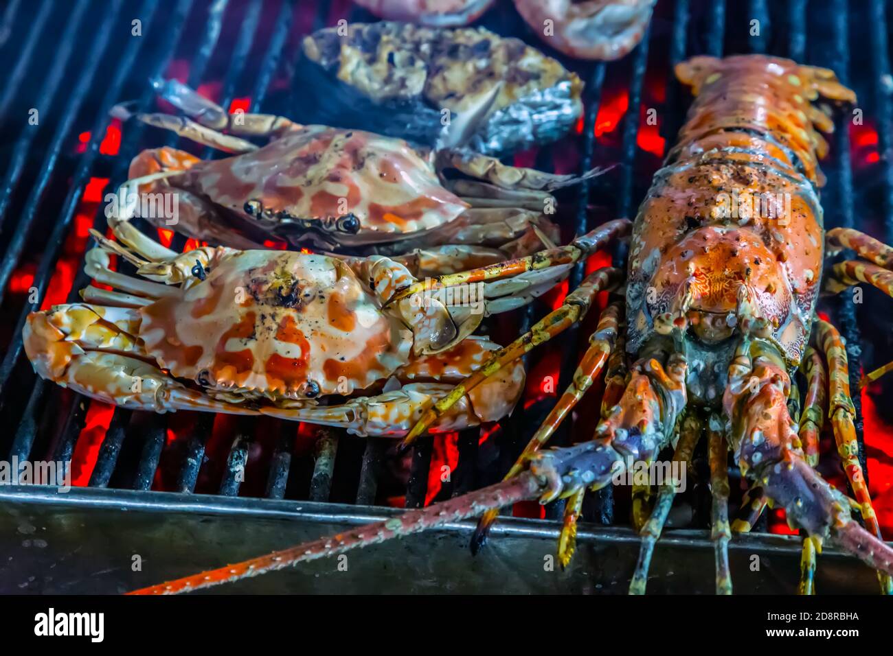 Lobsters crab grilled using charcoal grill with seafood Stock Photo - Alamy