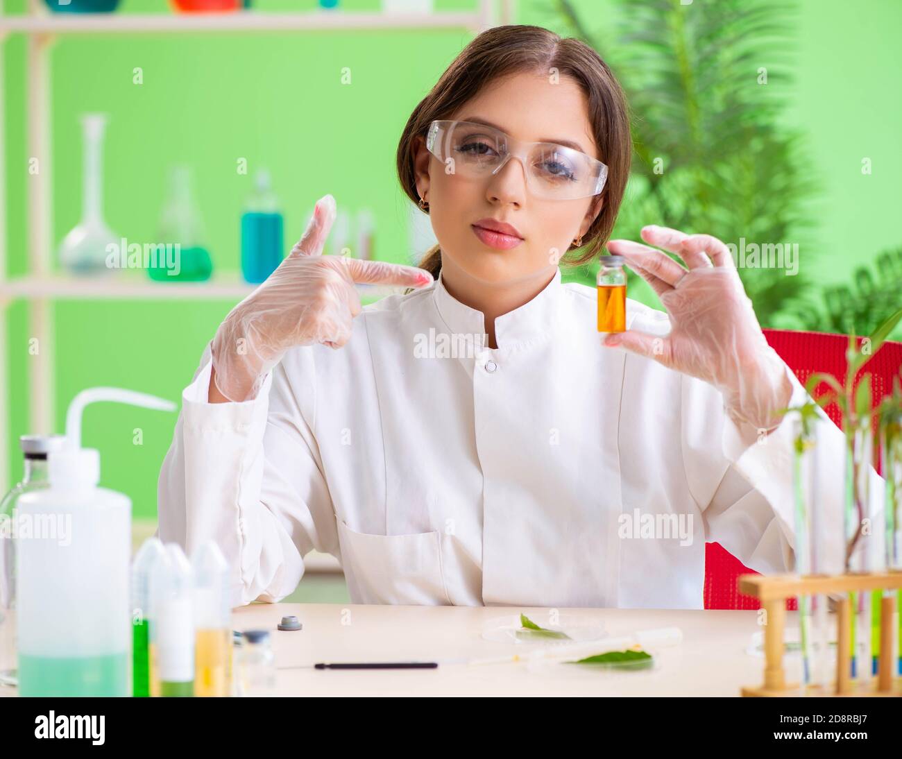 The beautiful female biotechnology scientist chemist working in lab ...