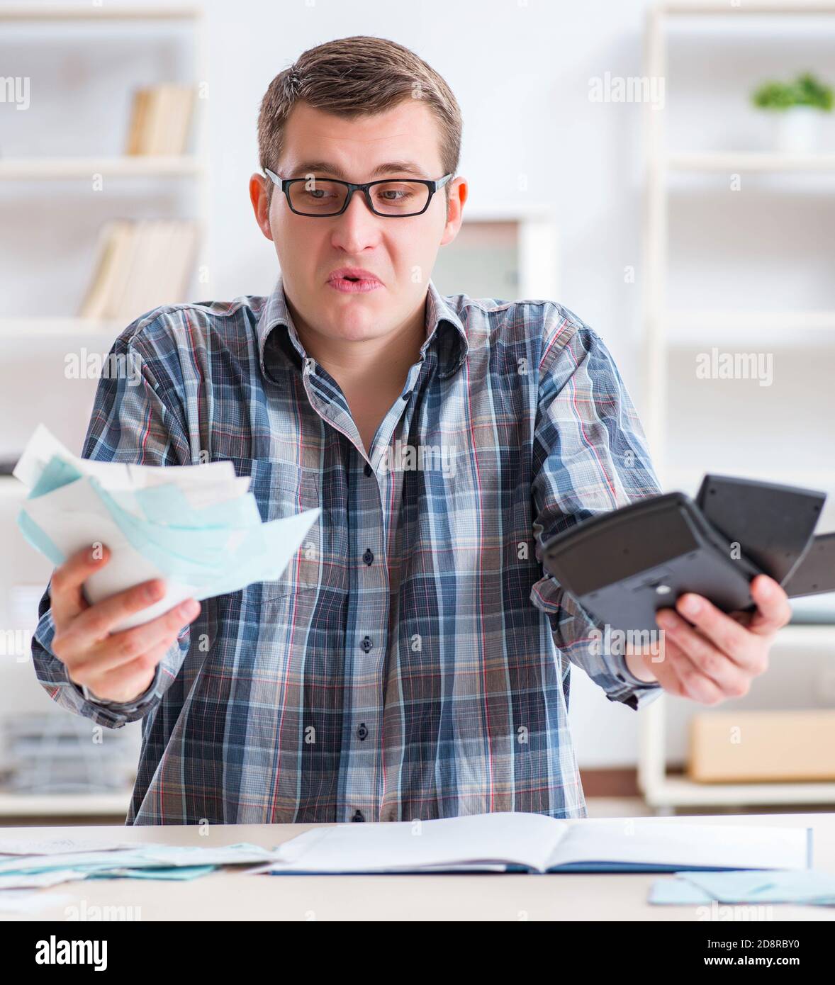 The young man frustrated at his house and tax bills Stock Photo - Alamy