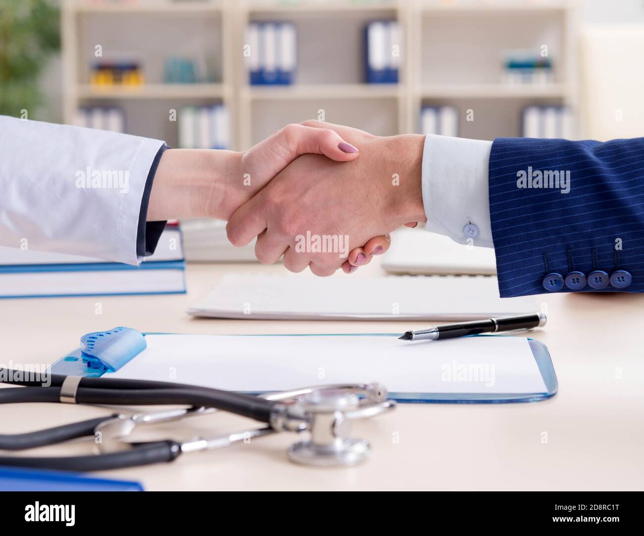 The man signing medical insurance contract Stock Photo - Alamy