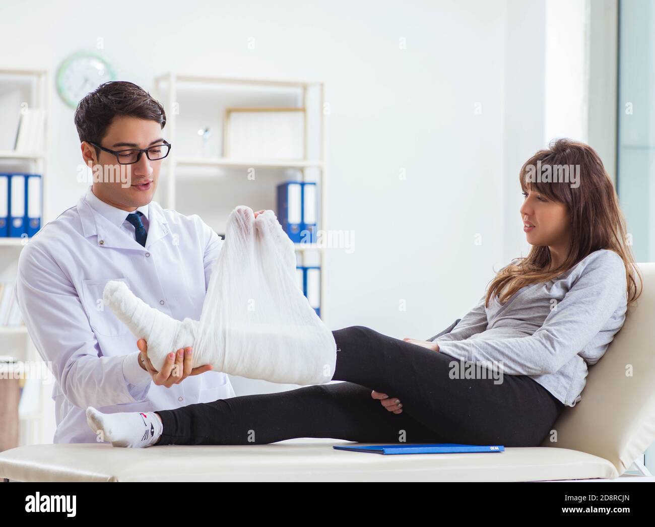 The doctor examining patient with broken leg Stock Photo - Alamy