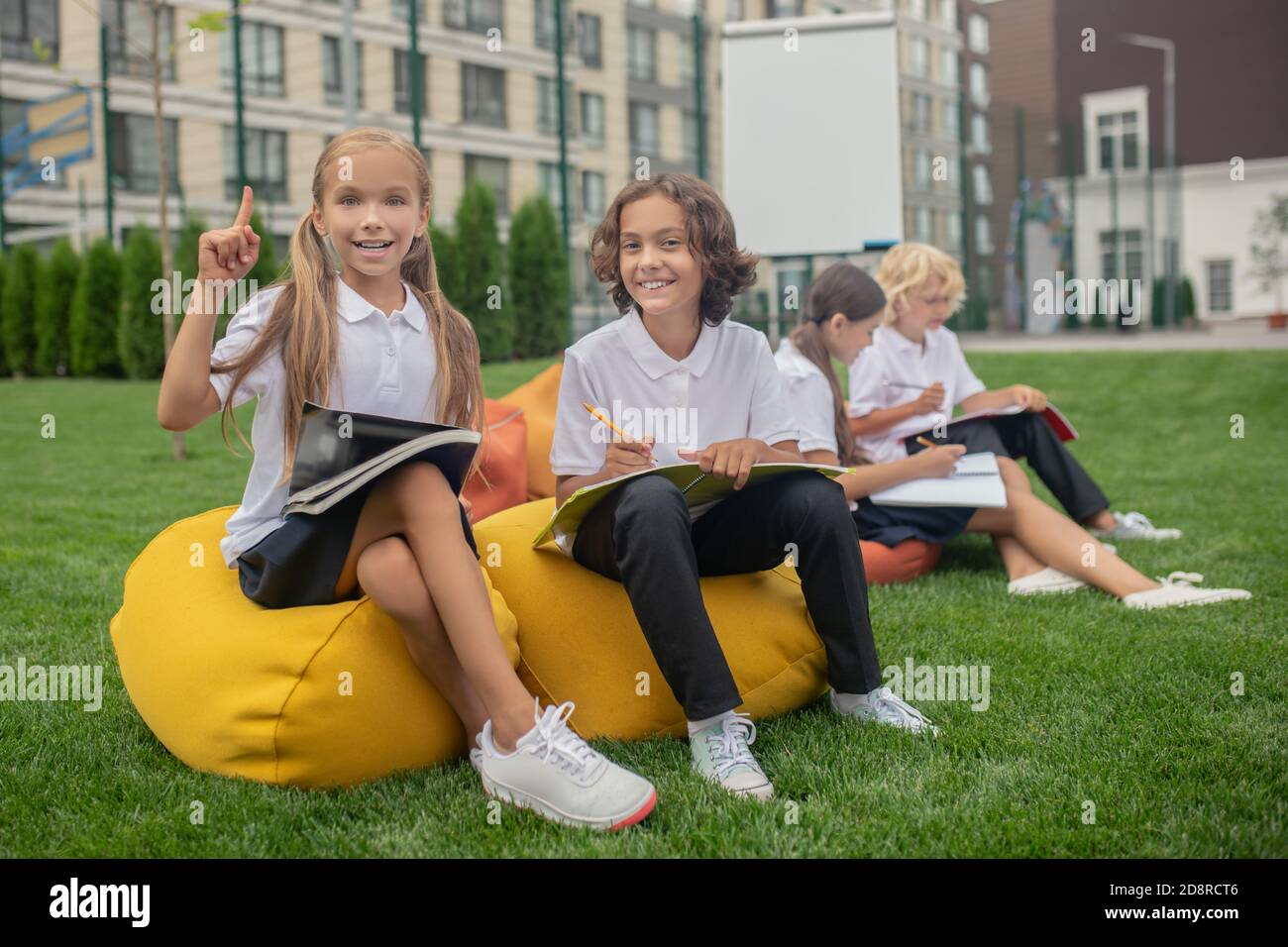 Two children work together at the lesson Stock Photo - Alamy