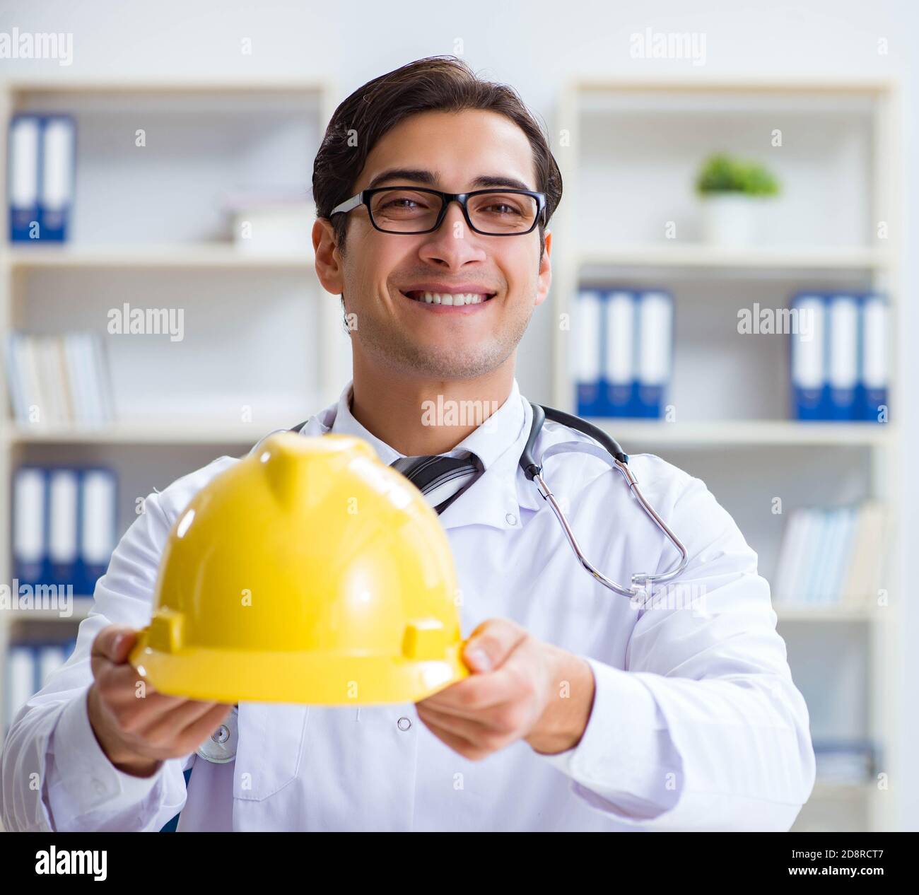 The safety doctor advising about wearing hard hat Stock Photo - Alamy