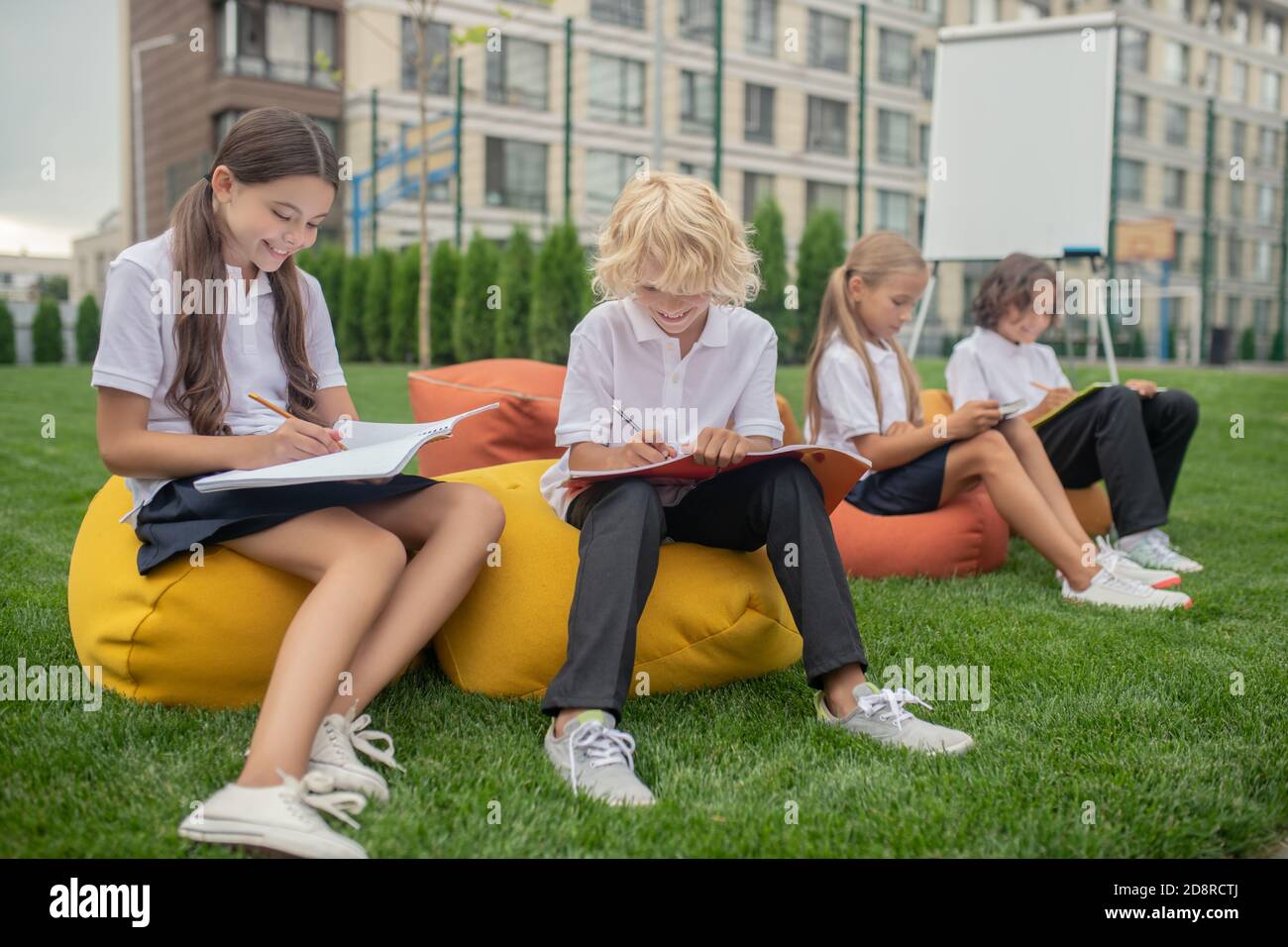 Two children work together at the lesson and looking busy Stock Photo ...
