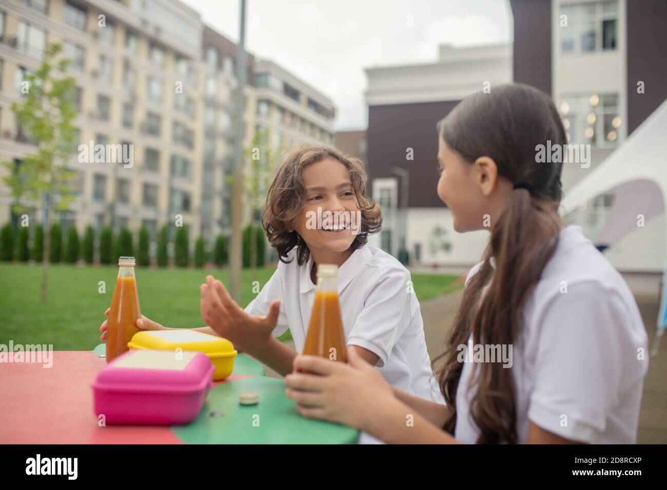 Friends having lunch together and smiling to each other Stock Photo - Alamy