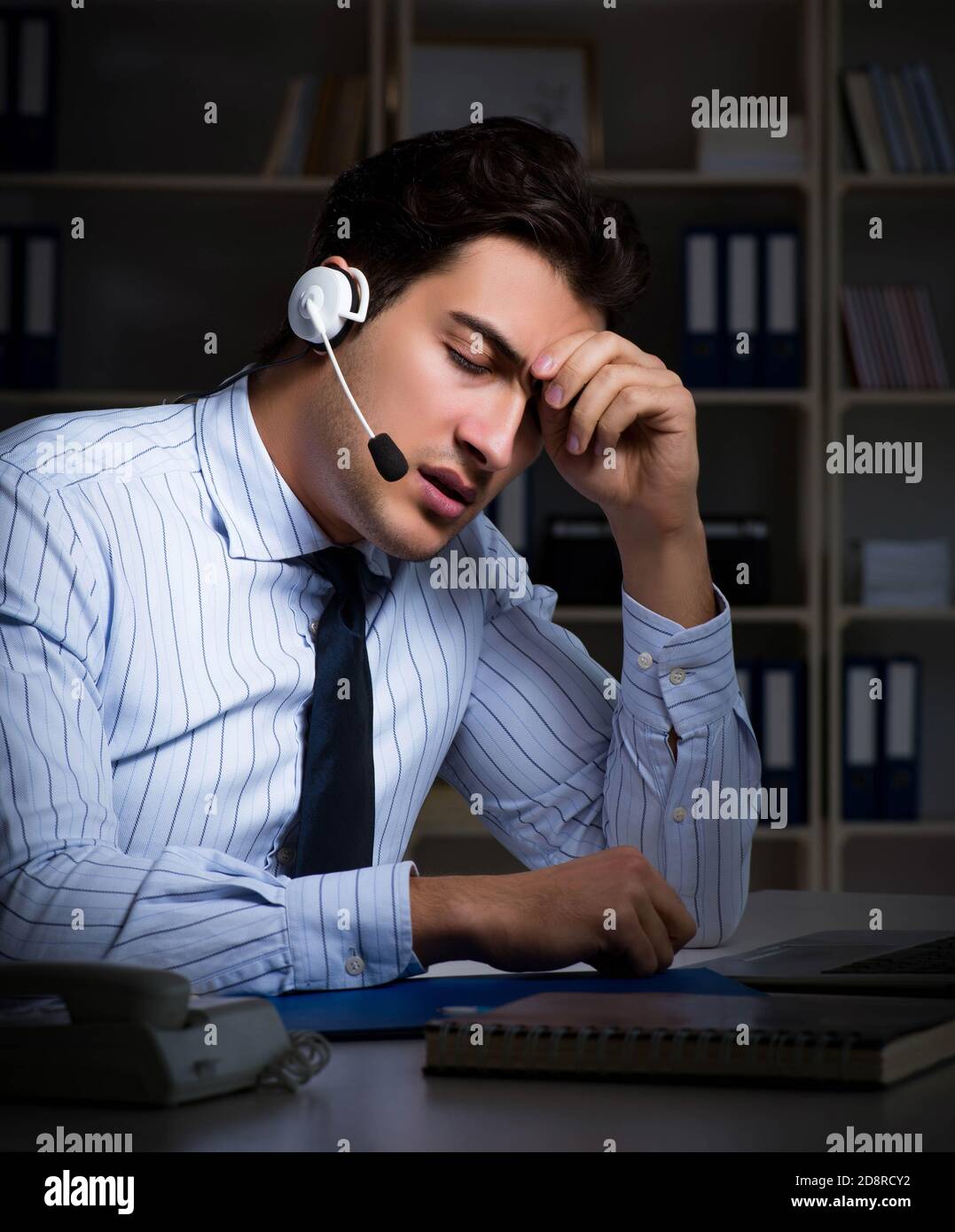The tired and exhausted helpdesk operator during night shift Stock ...