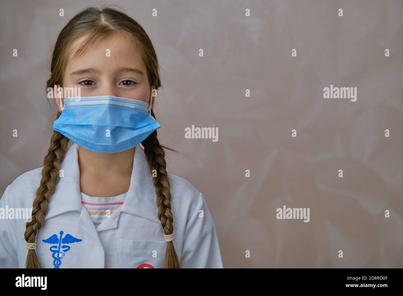 A child playing doctor in mask on a light background Stock Photo - Alamy