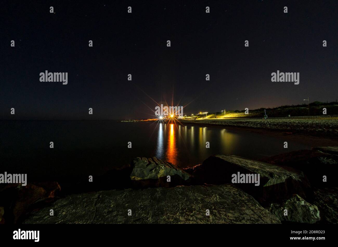 Night seascape with lights in the distance Stock Photo - Alamy
