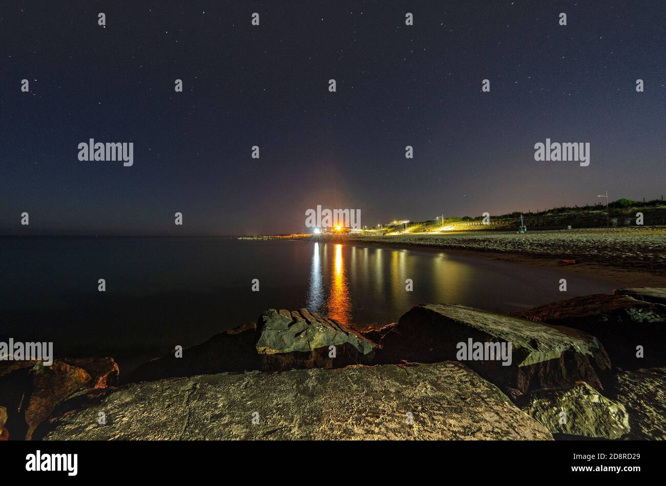 Night seascape with lights in the distance Stock Photo - Alamy