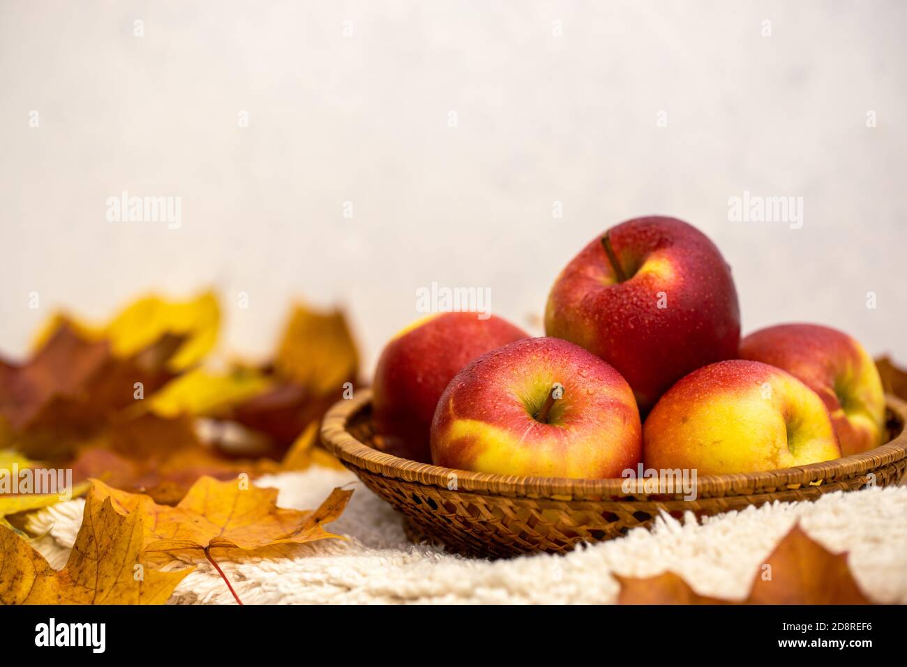 Colourful autumn apples and leaves in a basket Stock Photo - Alamy