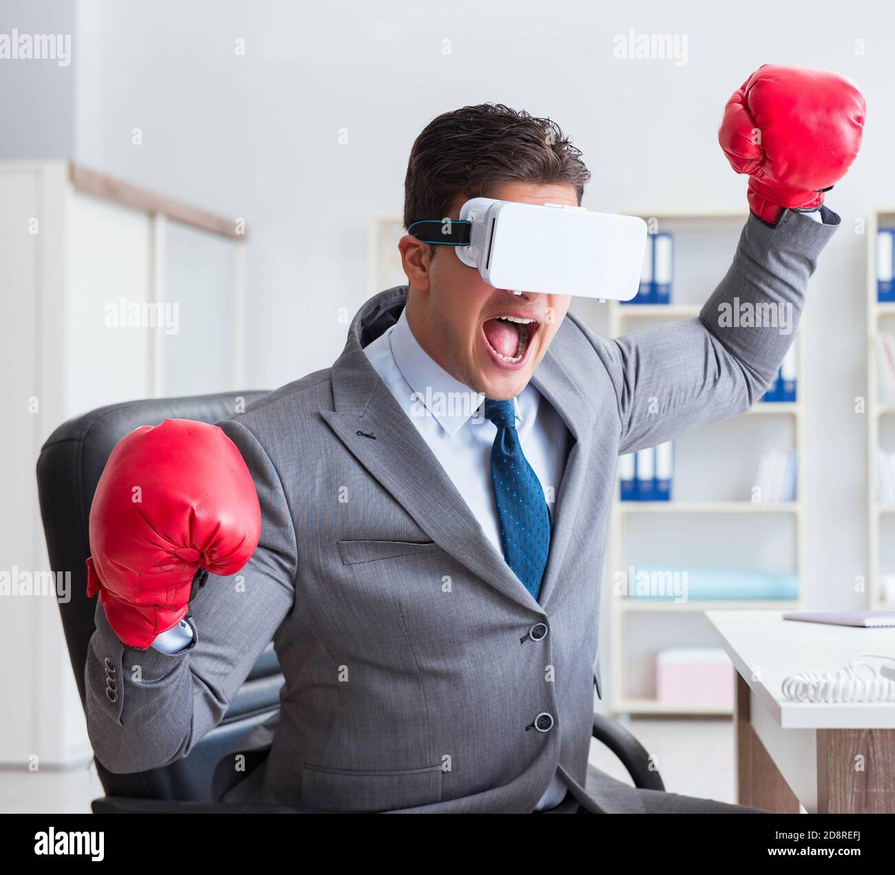 The man boxing in the office with virtual reality goggles Stock Photo ...