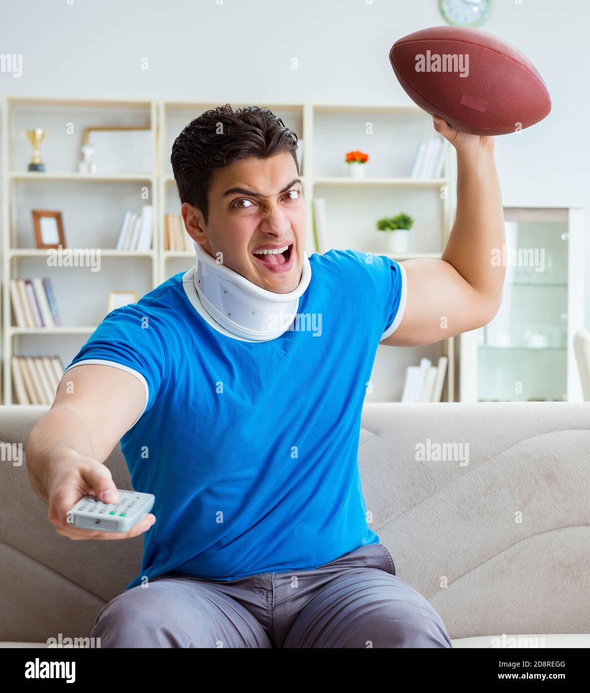 The man with neck injury watching american football at home Stock Photo ...