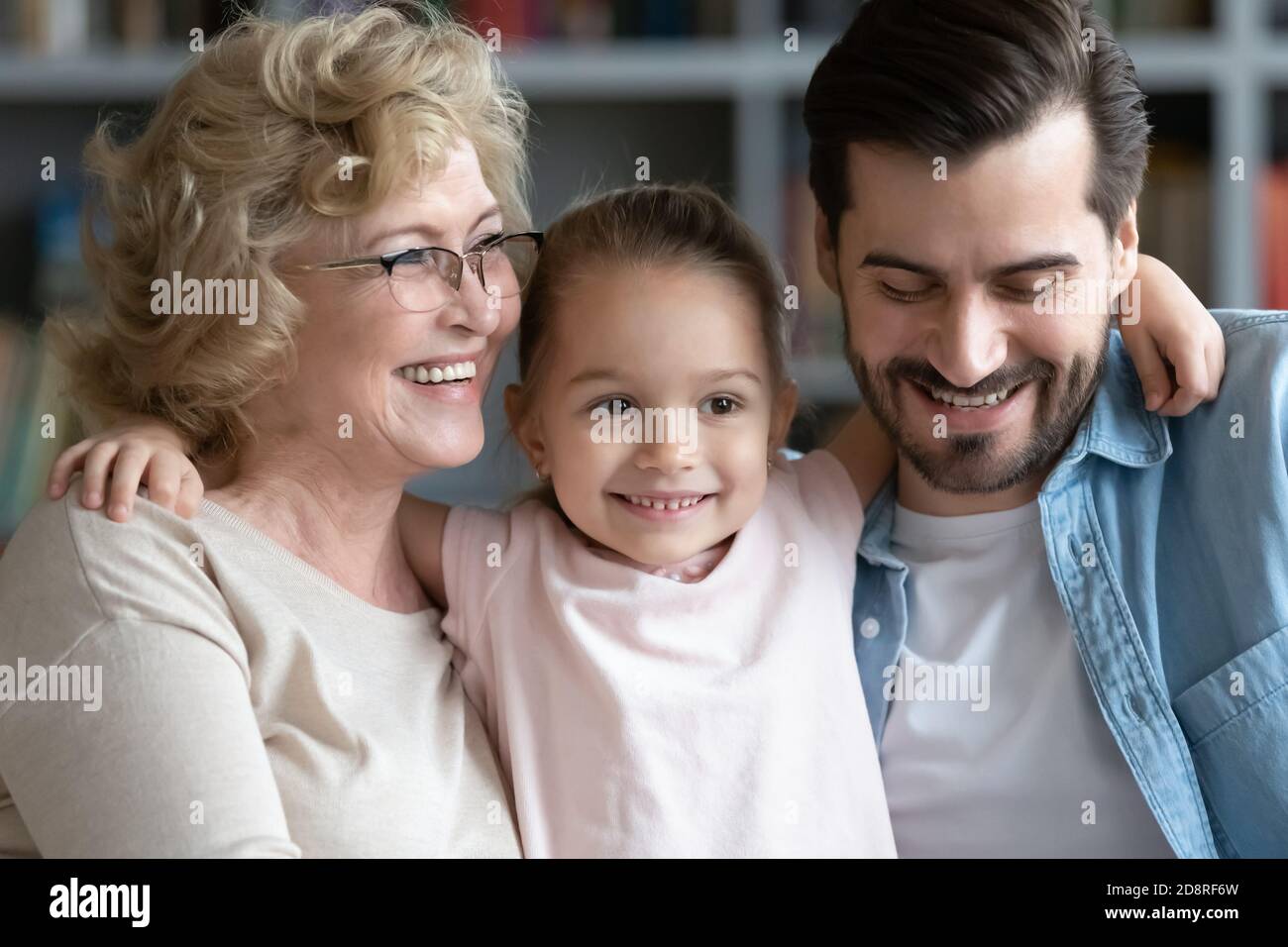 Happy three generations family enjoying sweet tender moment at home ...