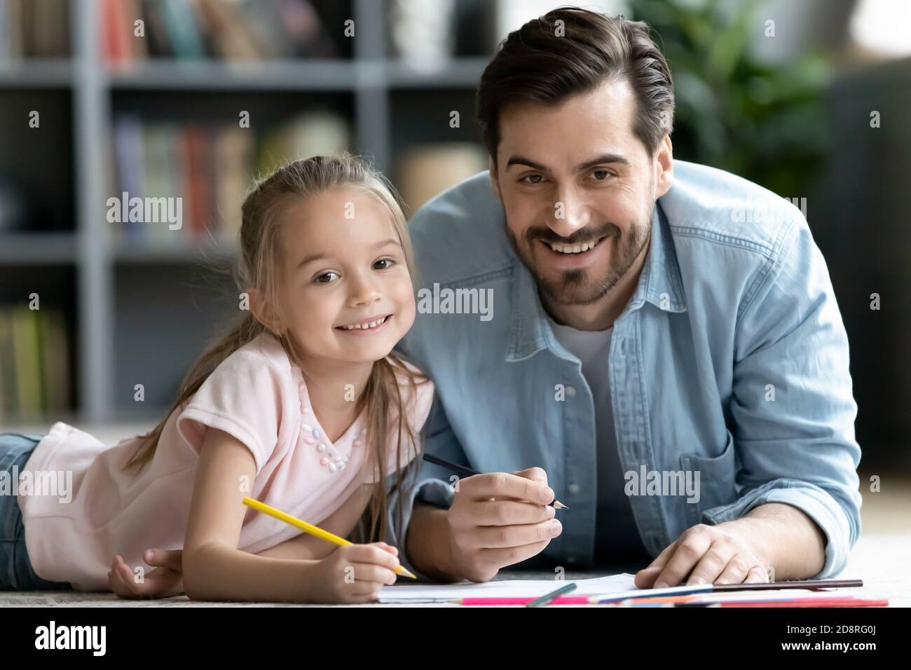 Young handsome father drawing pictures with daughter Stock Photo - Alamy