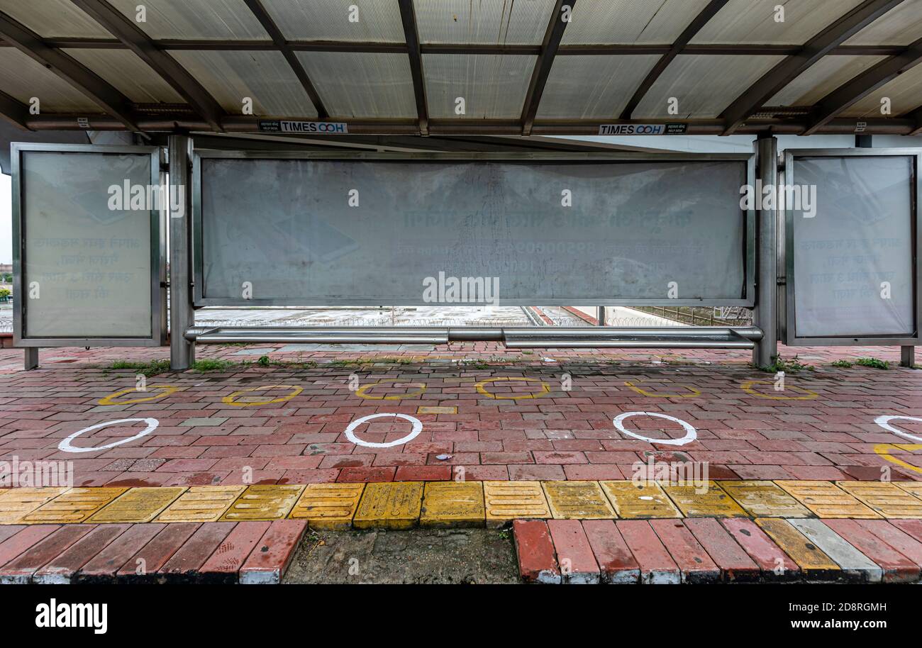 View of an empty bus shelter with marking for social distancing, public ...