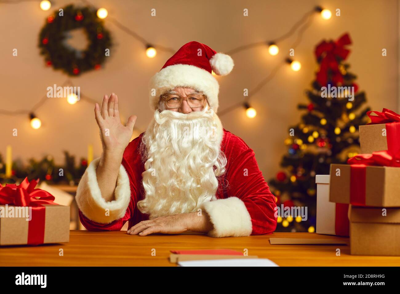 Santa Claus waving hand during video call or greeting his subscribers ...