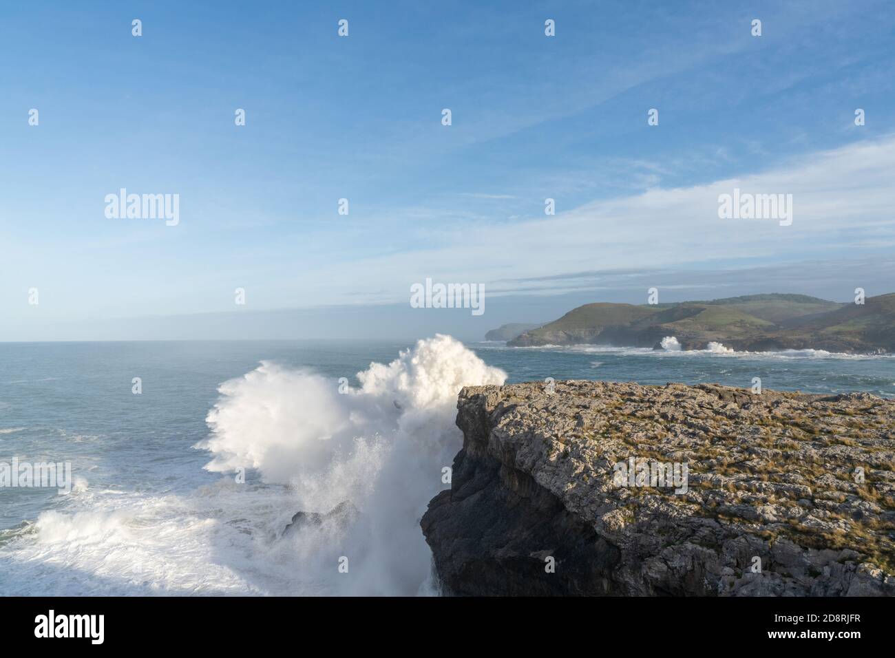 A view of huge storm surge ocean waves crashing onto shore and cliffs ...